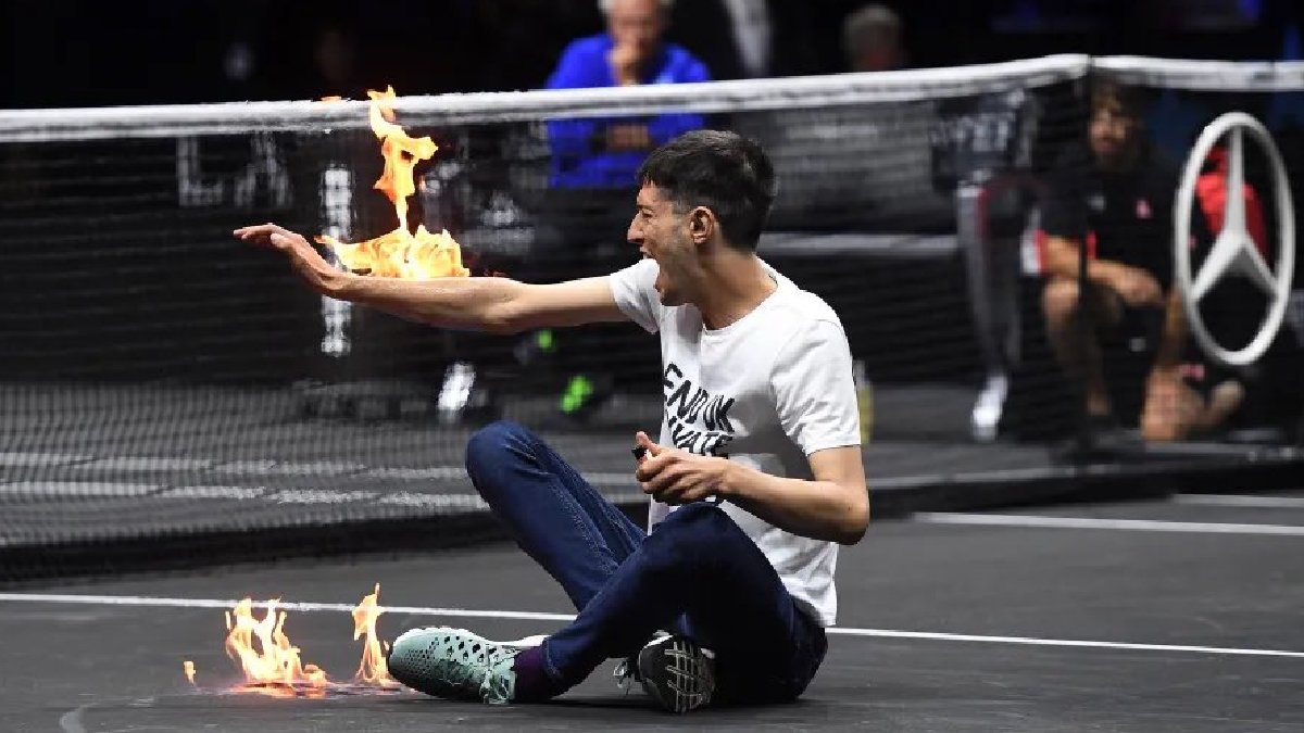 Stefanos Tsitsipas keeps composure to win as protester sets arm on fire